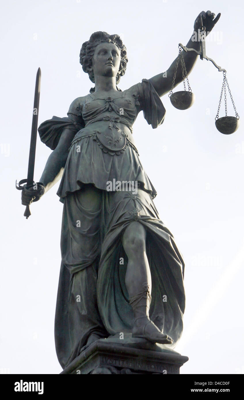 The picture shows a statue of the Roman goddess of justice on the ...
