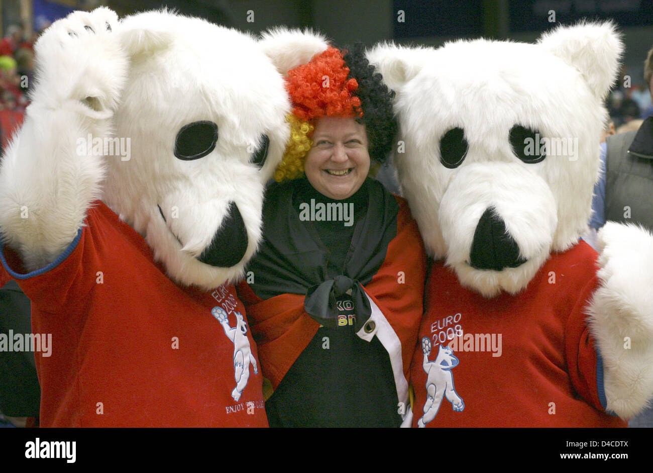 A German fan poses with the tournament's mascots before the EHF Euro ...