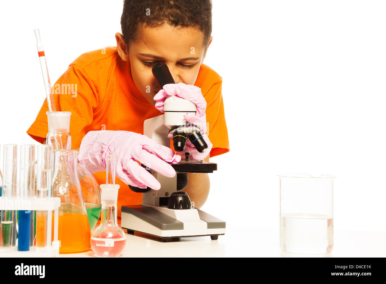 Cute black boy with short hair in chemistry lab class with microscope ...