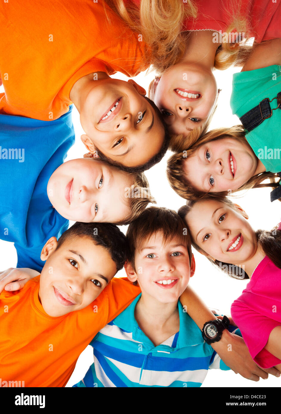 7 kids looking down standing in a circle smiling and looking down Stock ...