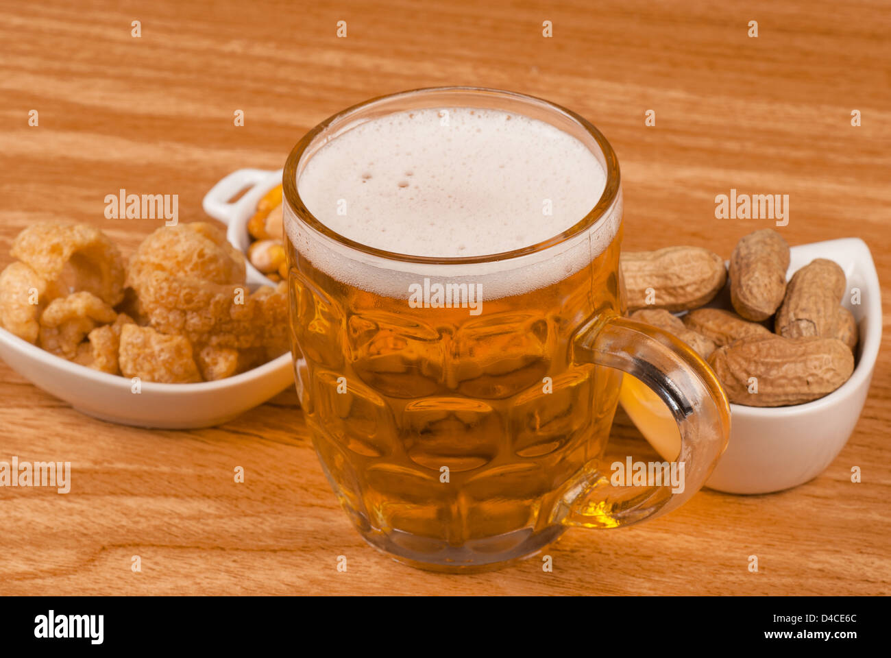 Tankard of beer and an assortment of crunchy snacks Stock Photo - Alamy