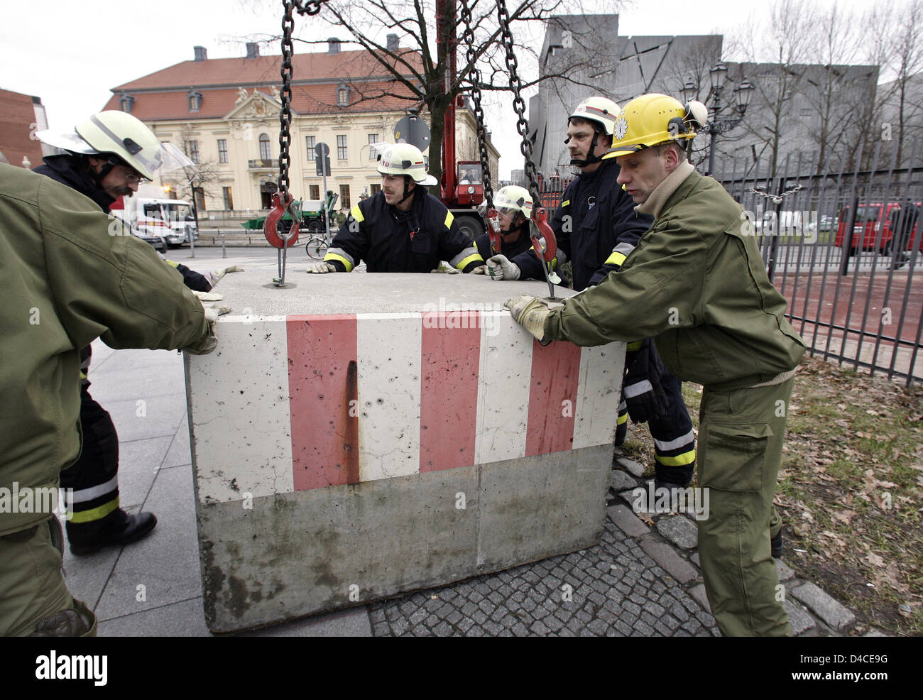 Police officers and fire fighters position cement blocks at the Jewish ...