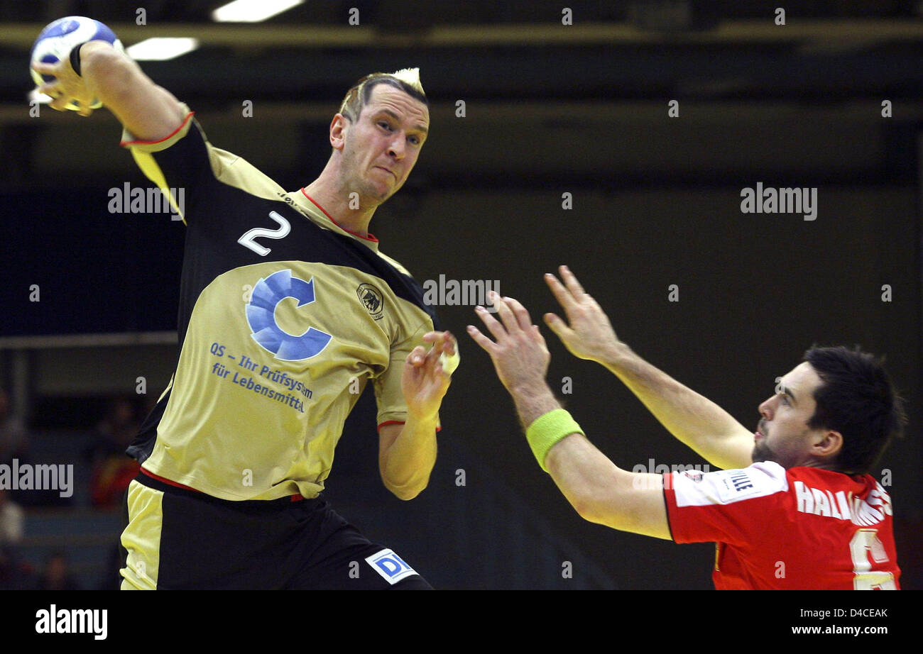 Pascal Hens of Germany (L) is challenged by Iceland's Asgeir Oern ...