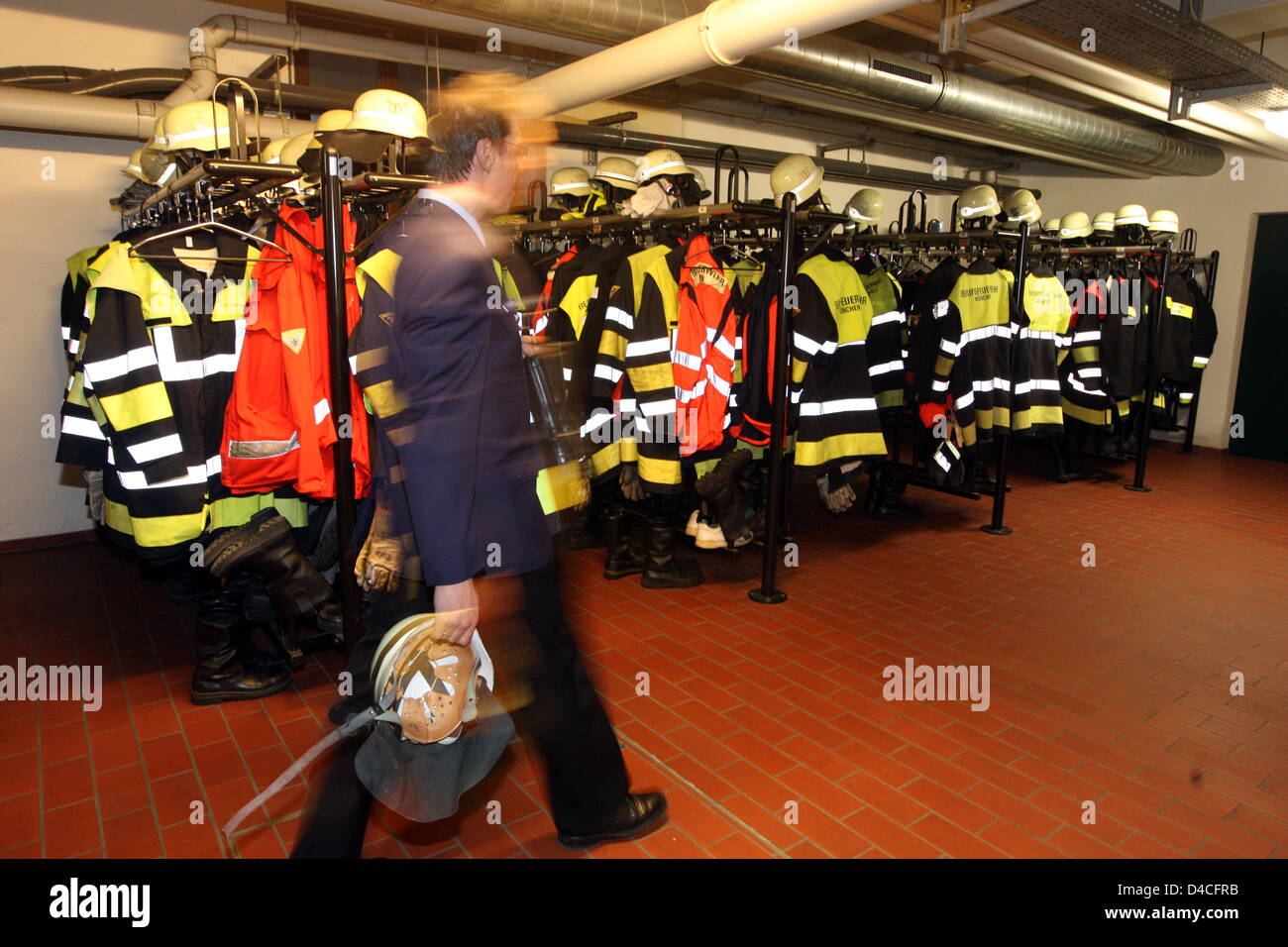 A fire fighter puts on his uniform at the firewarden 1 in Munich ...