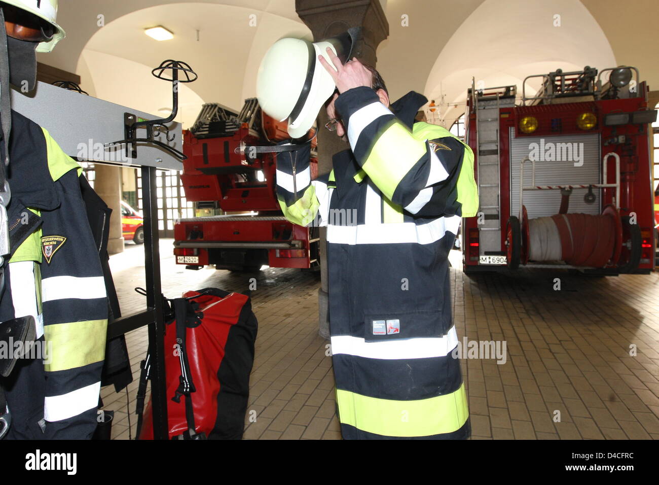 A fire fighter puts on his uniform at the firewarden 1 in Munich ...