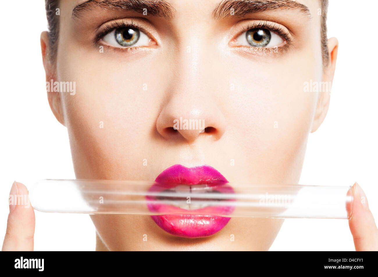 Beauty portrait of woman holding laboratory test tube in her lips ...