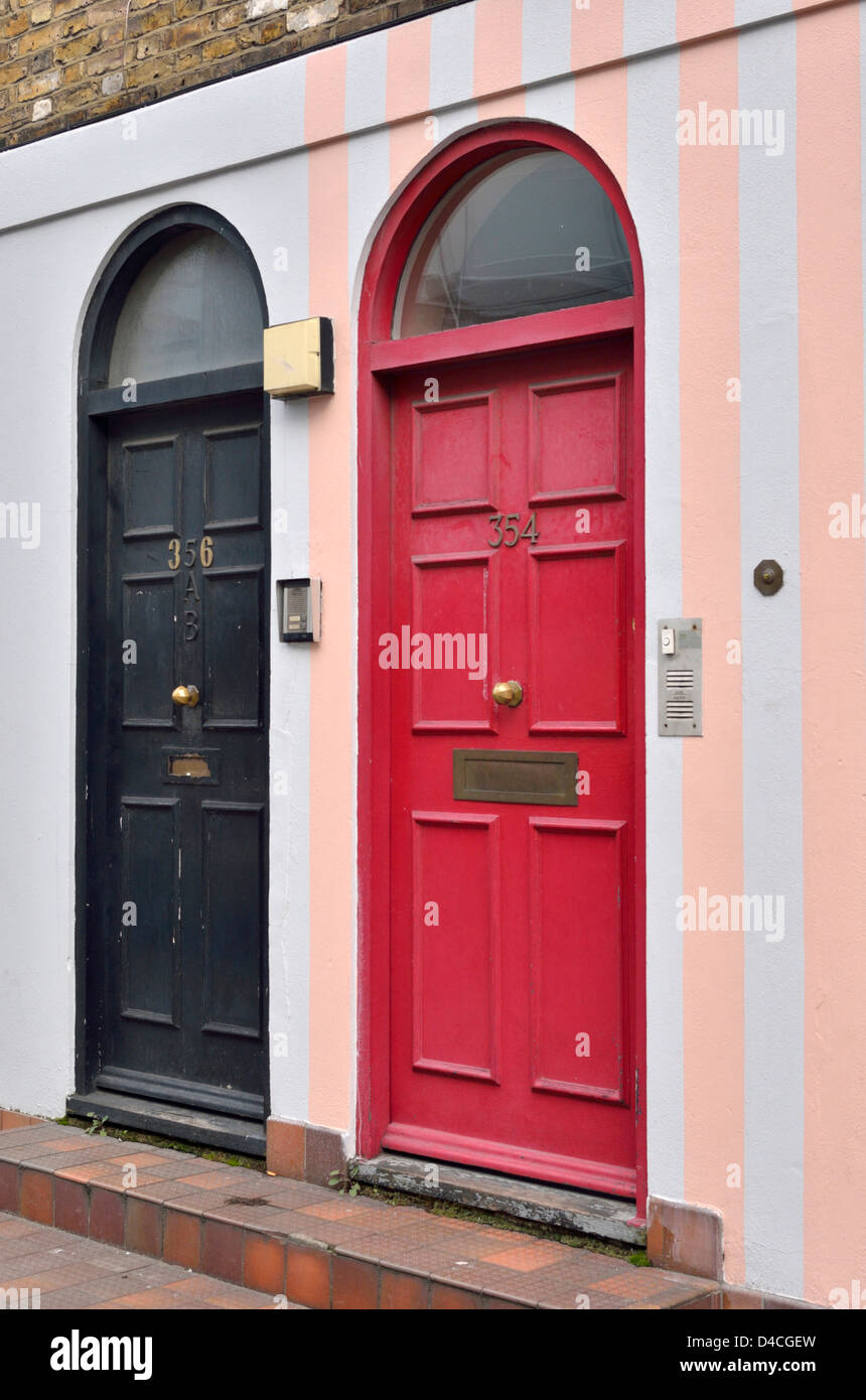 Two adjacent doors, one red and one black Stock Photo - Alamy