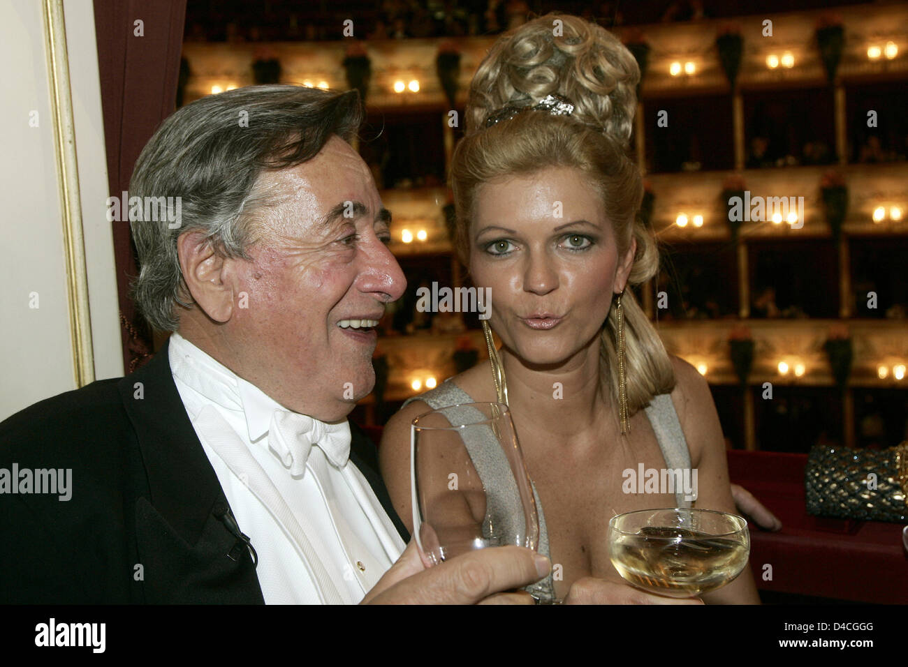 Construction mogul Richard Lugner chats with his grilfriend Bettina ...