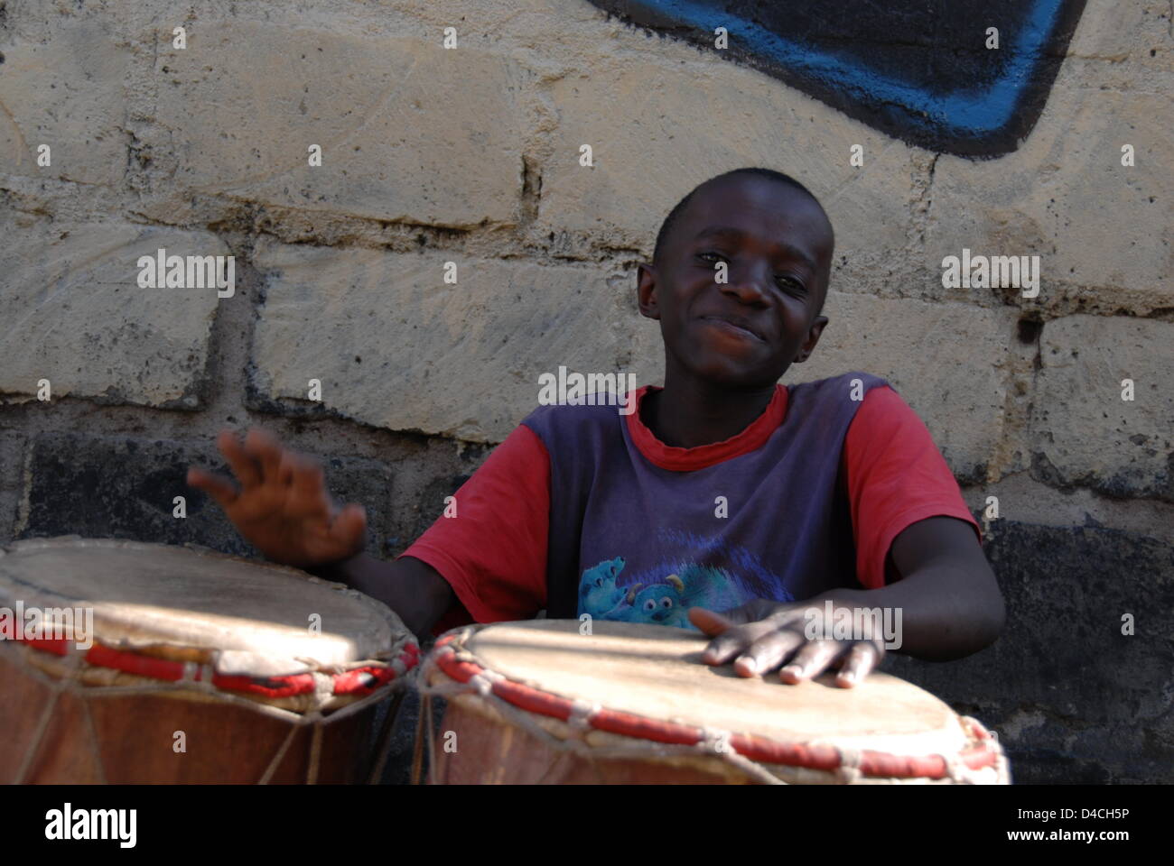 A boy beats the drums in a youth project of the Mathare Youth Sports ...