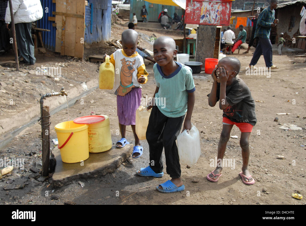 Children fetch water from a public tap in the Mathare sector of Nairobi ...