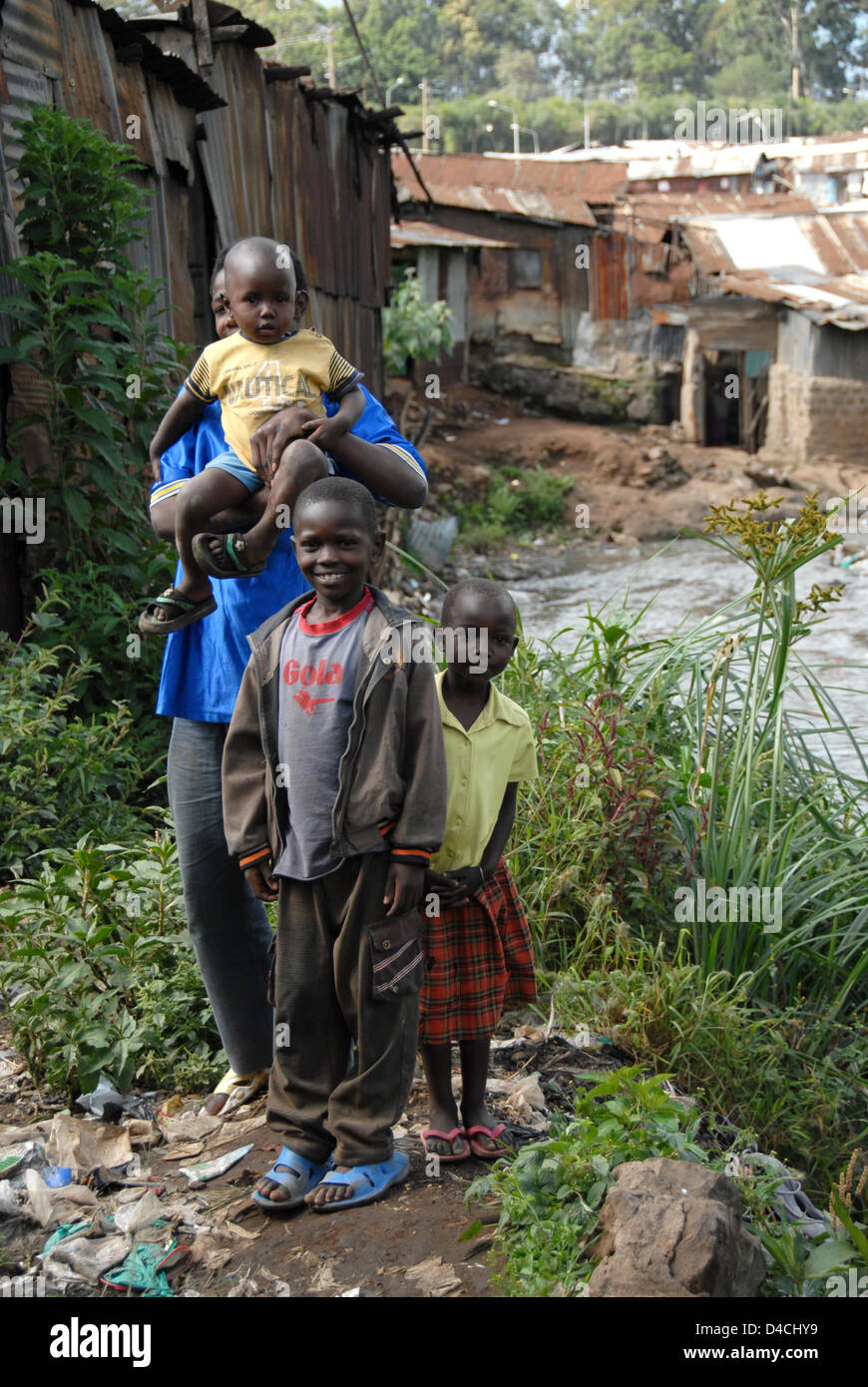A family stands in front of their hut in the Mathare sector of Nairobi ...