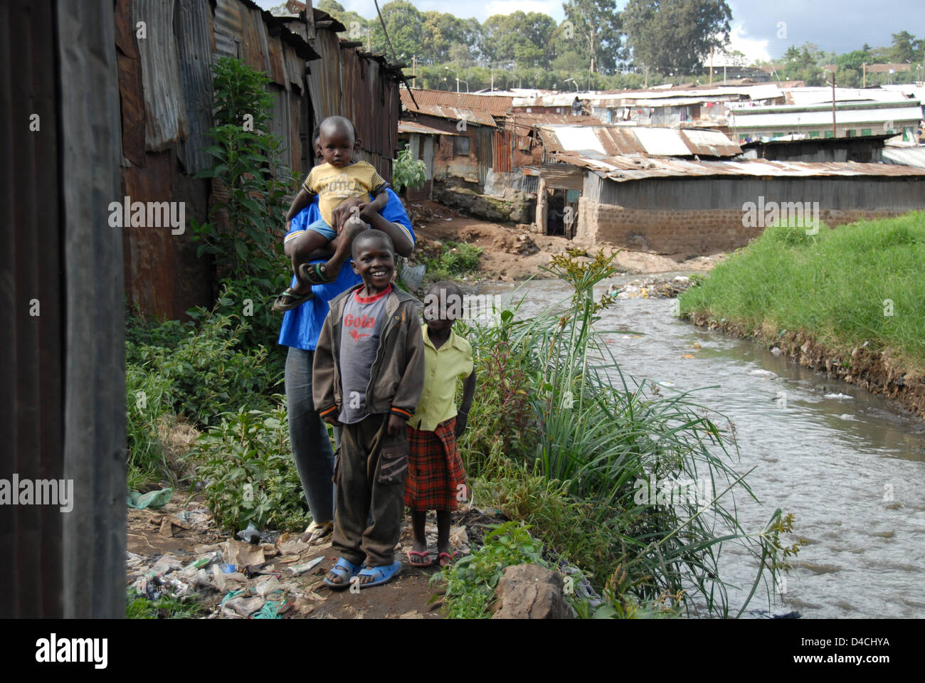 A family stands in front of their hut in the Mathare sector of Nairobi ...