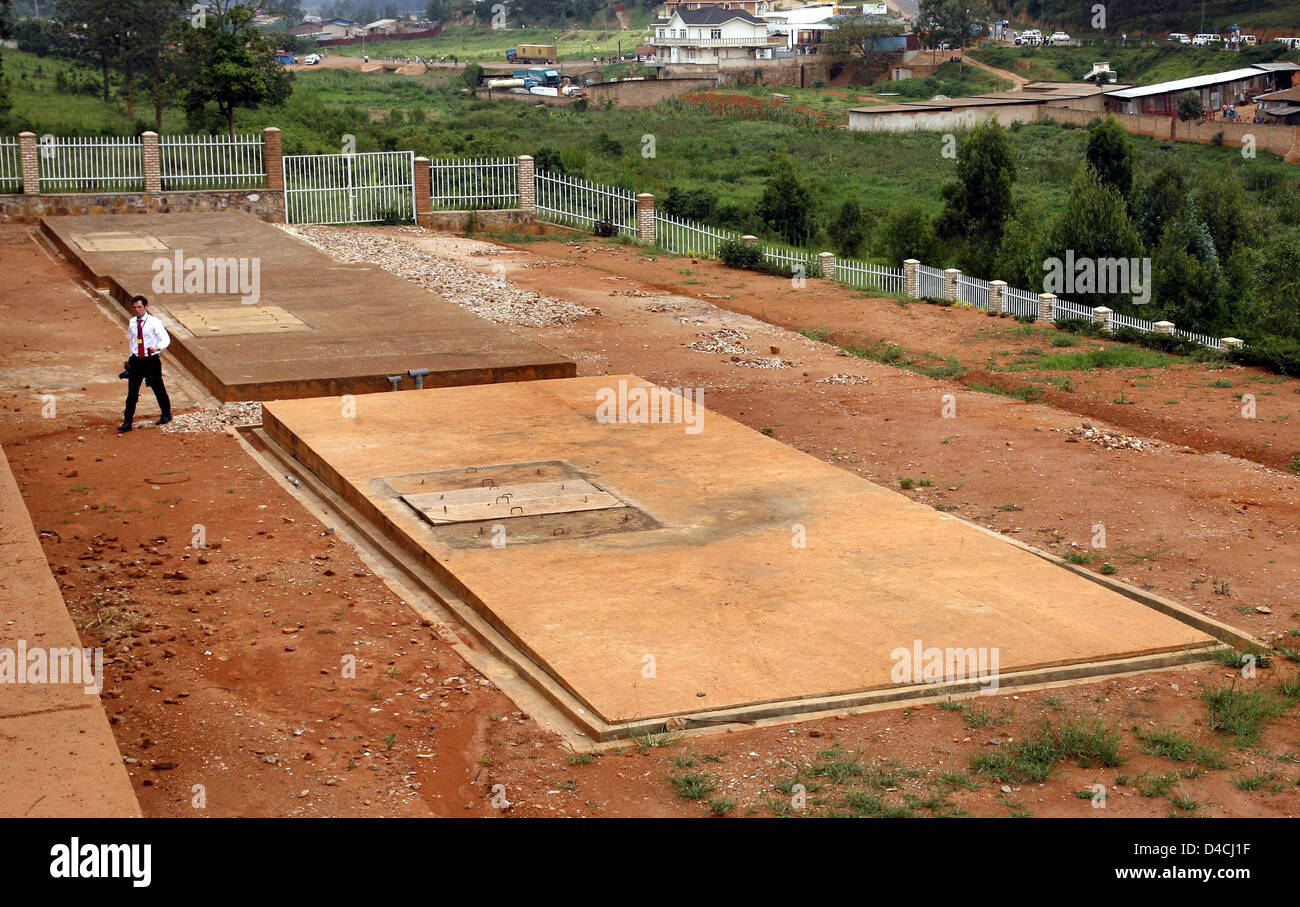 A journalist walks past the mass graves at the genocide memorial Gisozi ...