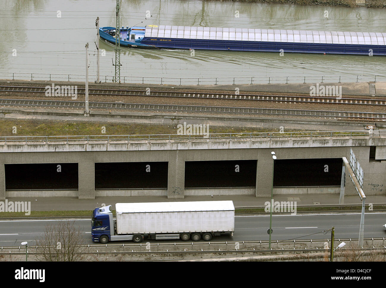 (top-bottom) A cargo ship, railway tracks and a lorry are three means ...