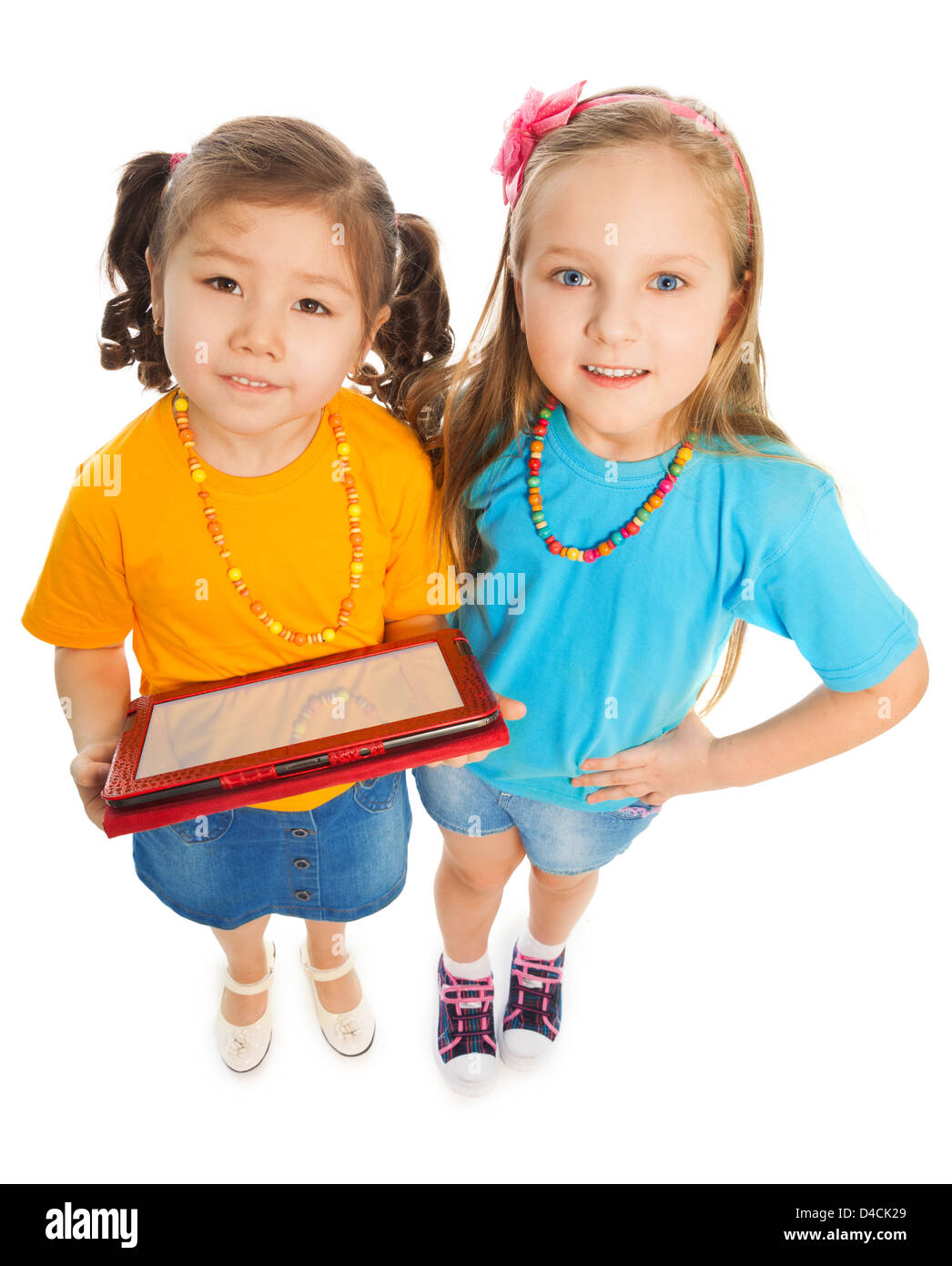 Two smart girls with digital tablet computer standing isolated on white ...