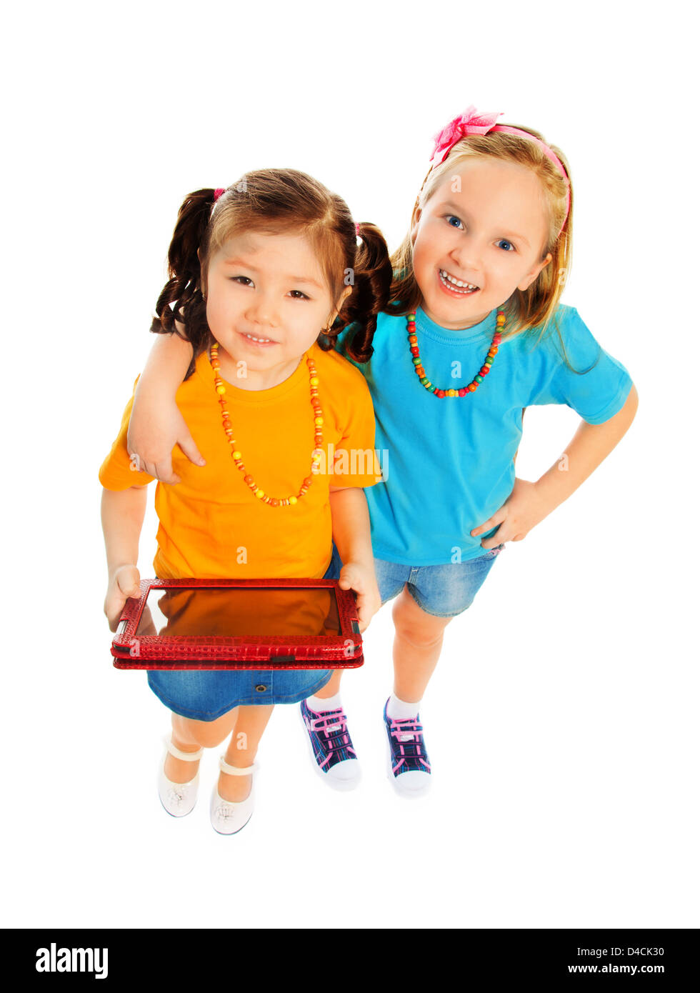 Two smart girls with digital tablet computer standing and hugging ...