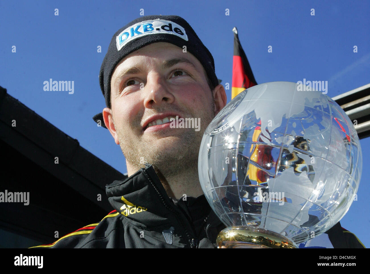 German bobsleigh pilot André Lange poses with the trophy at the ...