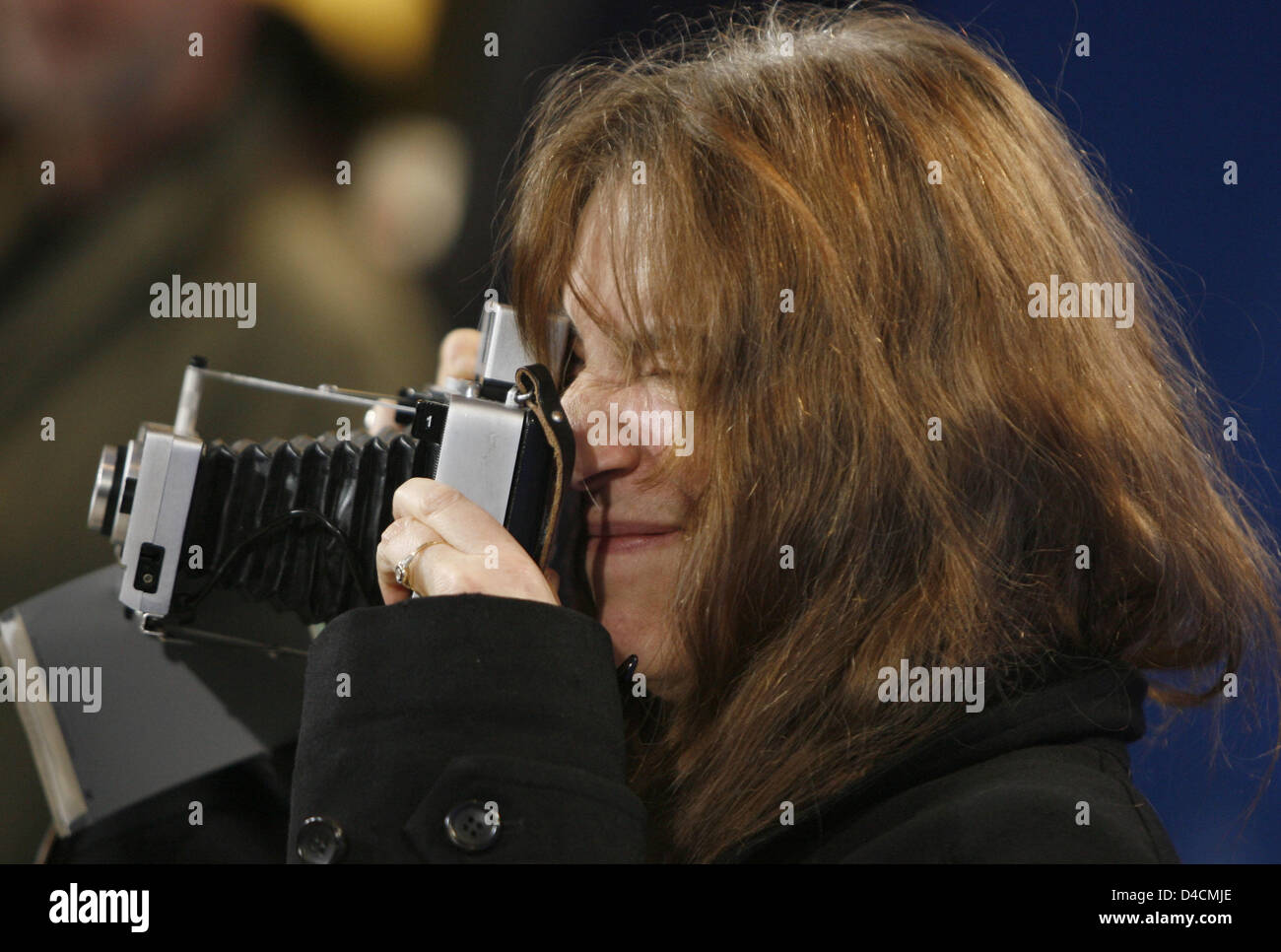 US singer Patty Smith takes pictures as she arrives for the screening ...