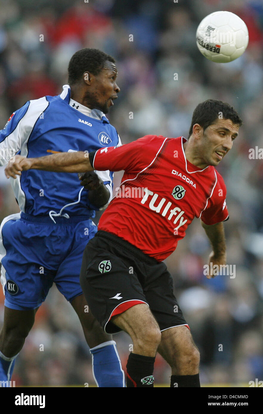 Altin Lala of Hanover (R) plays a header with Karlsruhe's Godfried ...