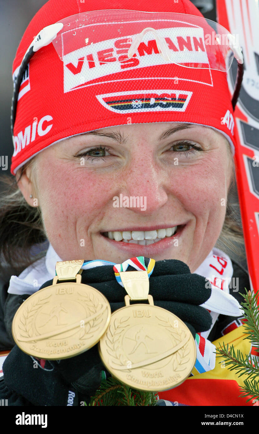 German Andrea Henkel shows her two gold medals after winning the ...
