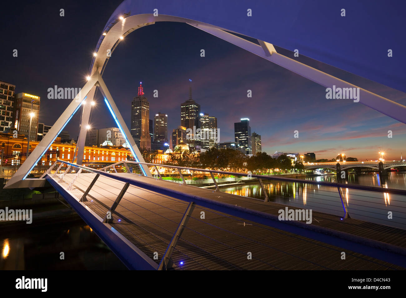 Southgate Bridge illuminated at twilight with city skyline in ...