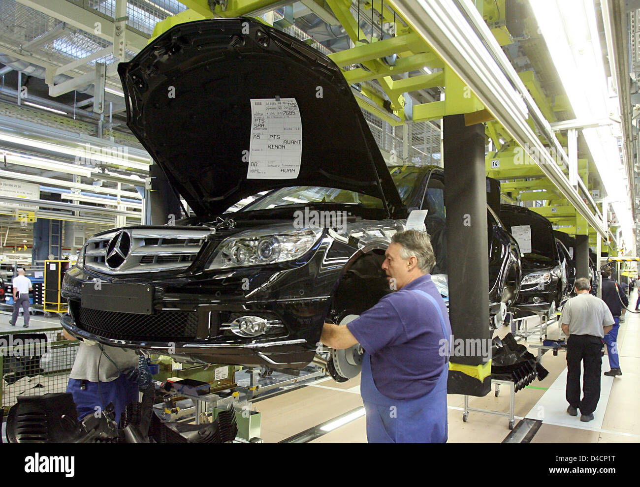 Employees of Daimler assemble Mercedes-Benz C-Class cars at the group's ...