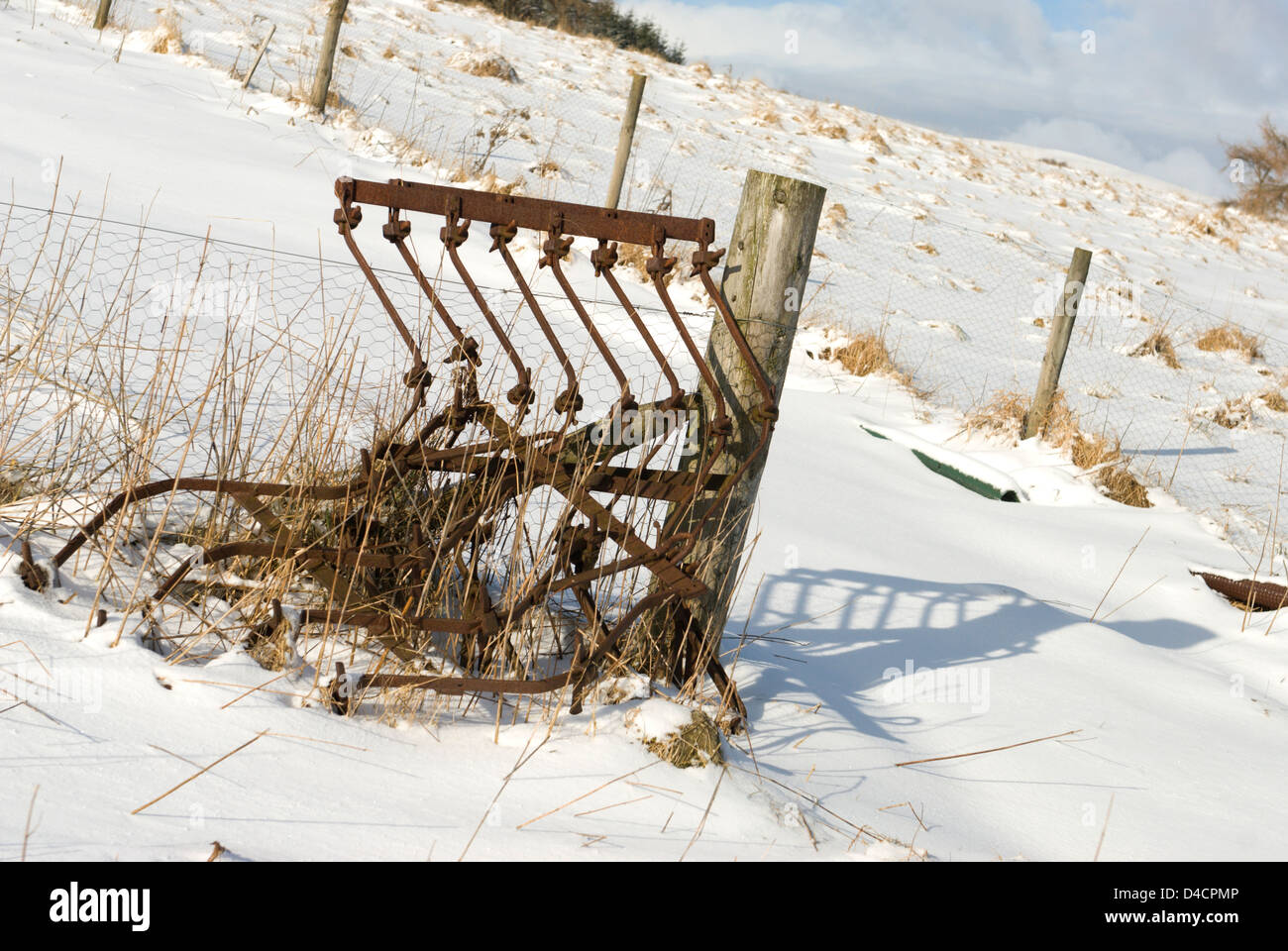 Rusty old farm implement abandoned in the snow Stock Photo - Alamy