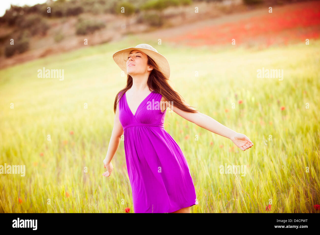 Young beautiful girl feeling freedom on meadow Stock Photo - Alamy