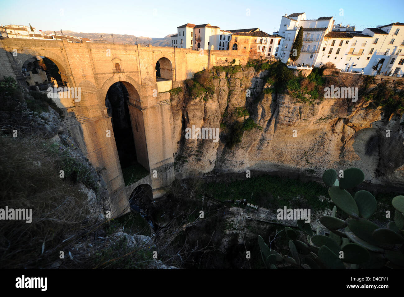 The picture shows a bridge over a deep canyon connecting two parts of ...