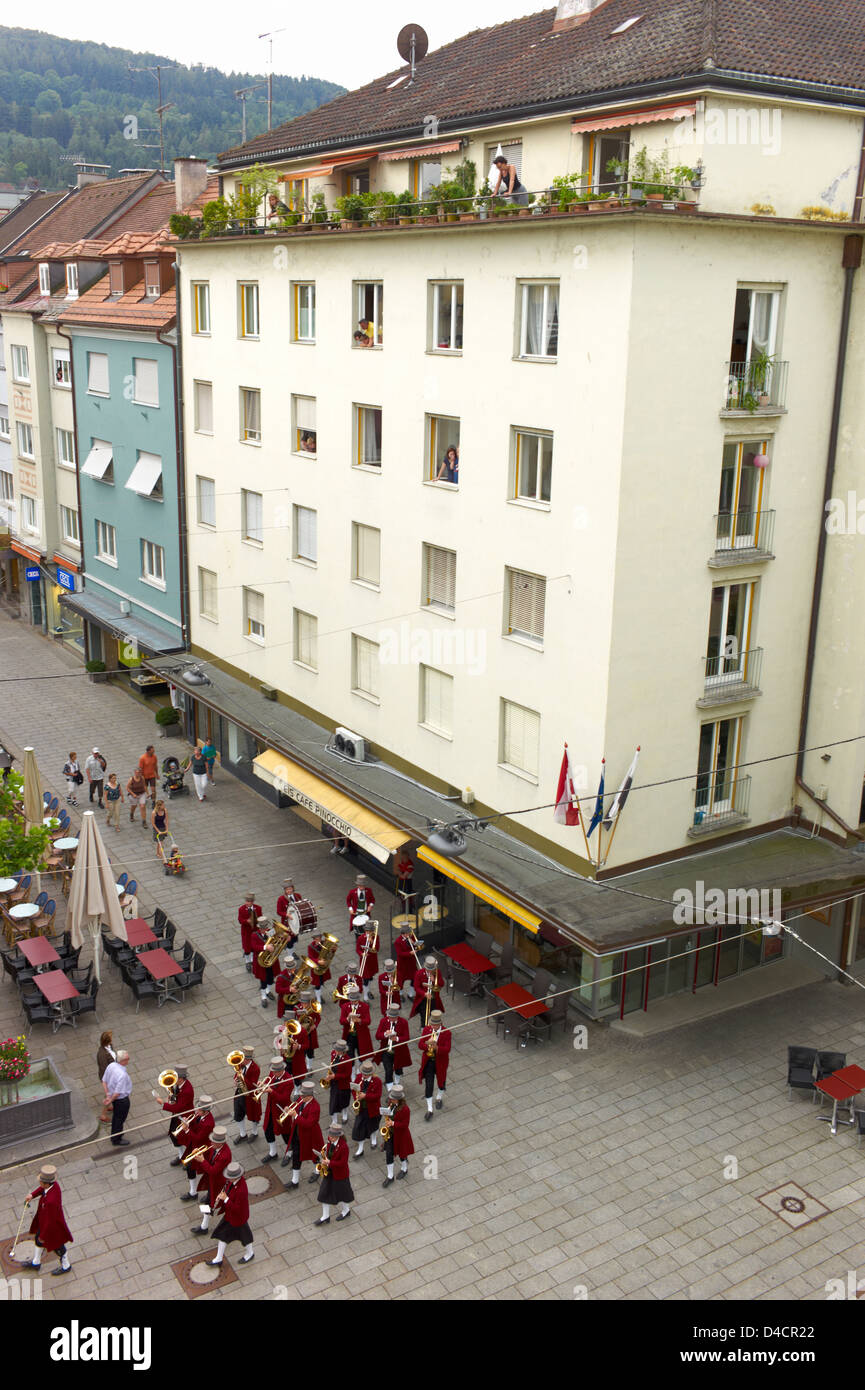A small marching band parading through the streets of a small town in ...