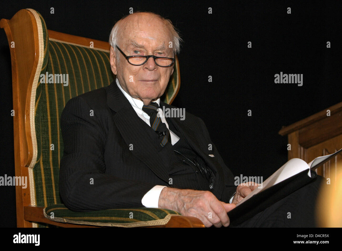 German comedian Vicco von Buelow, aka 'Loriot', sits in an arm chair ...