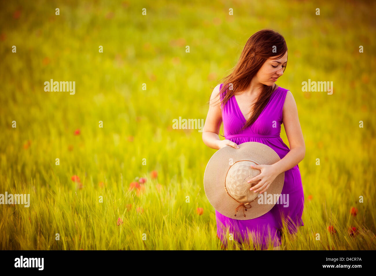 Young beautiful girl feeling freedom on meadow Stock Photo - Alamy