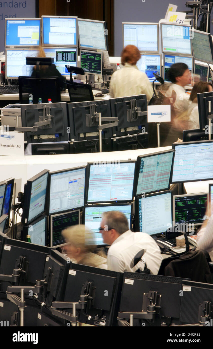 Brokers working at their screens on the floor of the stock exchange of ...