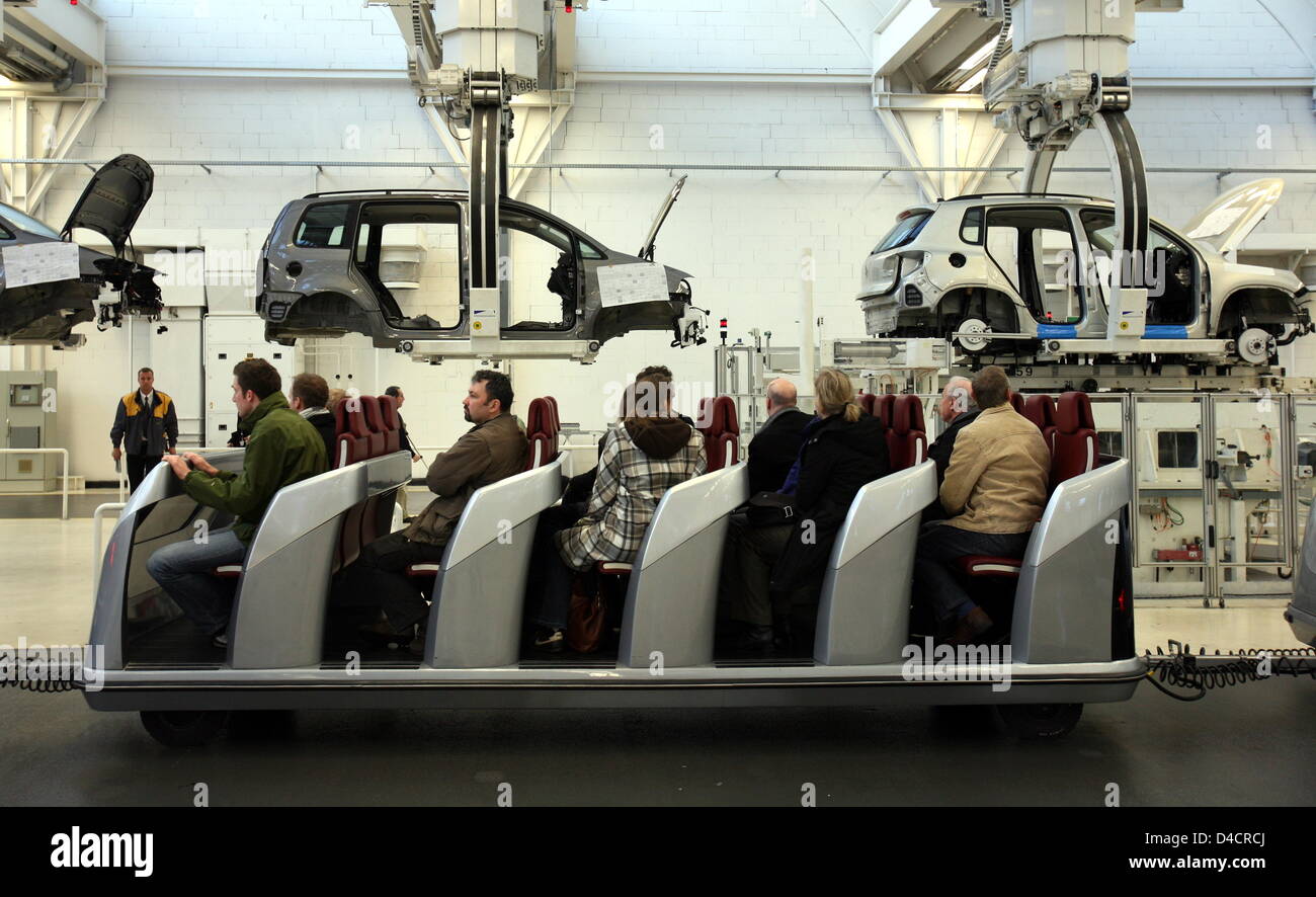 Visitors of Auto 5000 Ltd. watch the assembly of a Volkswagen (VW ...