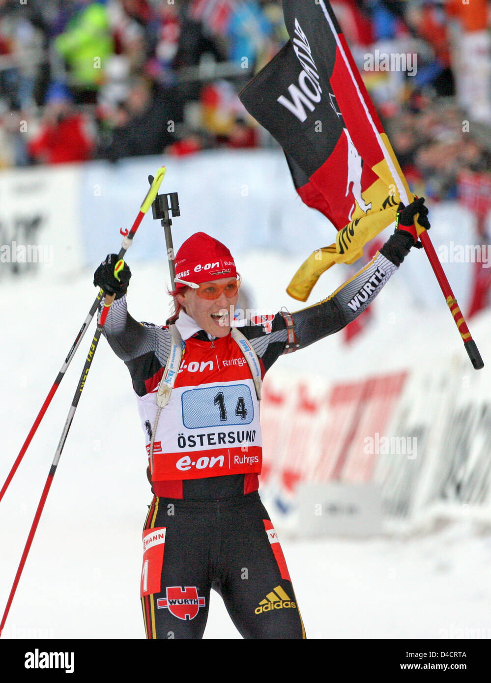 Kati Wilhelm of Germany crosses the finish line with a German flag in ...