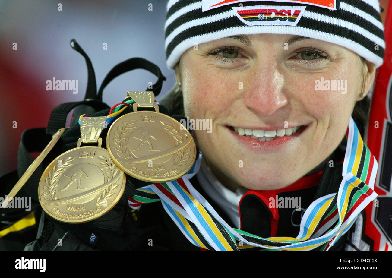 German Andrea Henkel poses with her gold medals after the women's 4 x ...