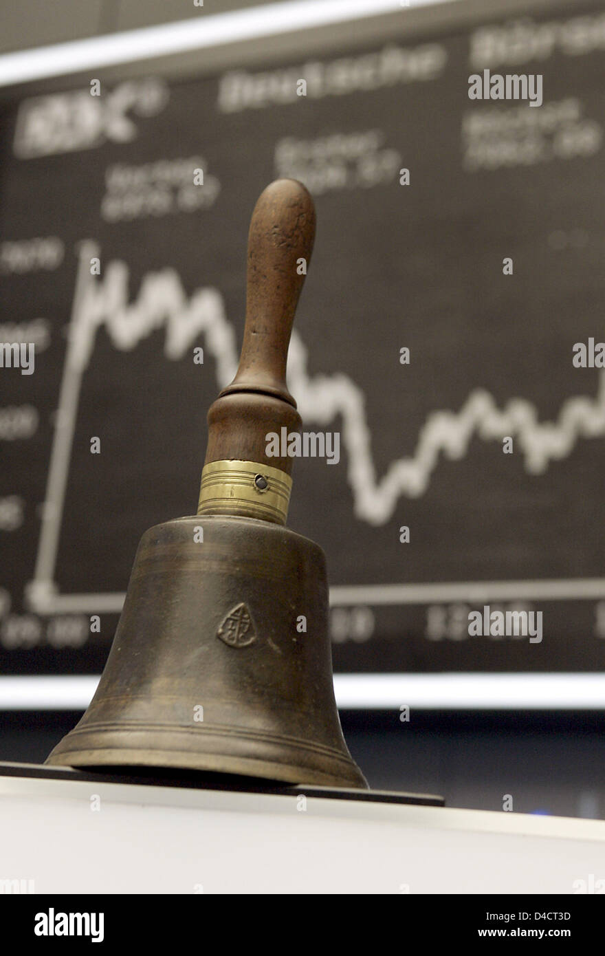 The traditional stock exchange bell is pictured in front of a display ...