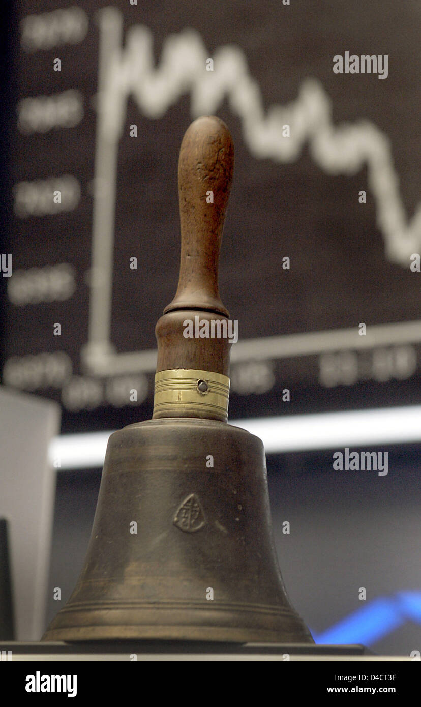 The traditional stock exchange bell is pictured in front of a display ...