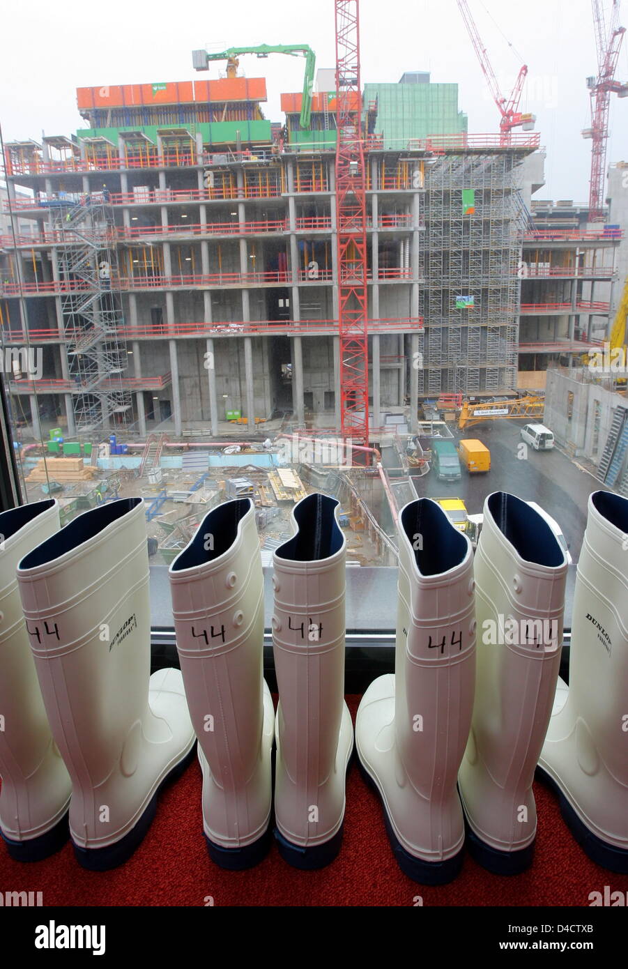 Rubber boots for journalists stand at the construction site of ...