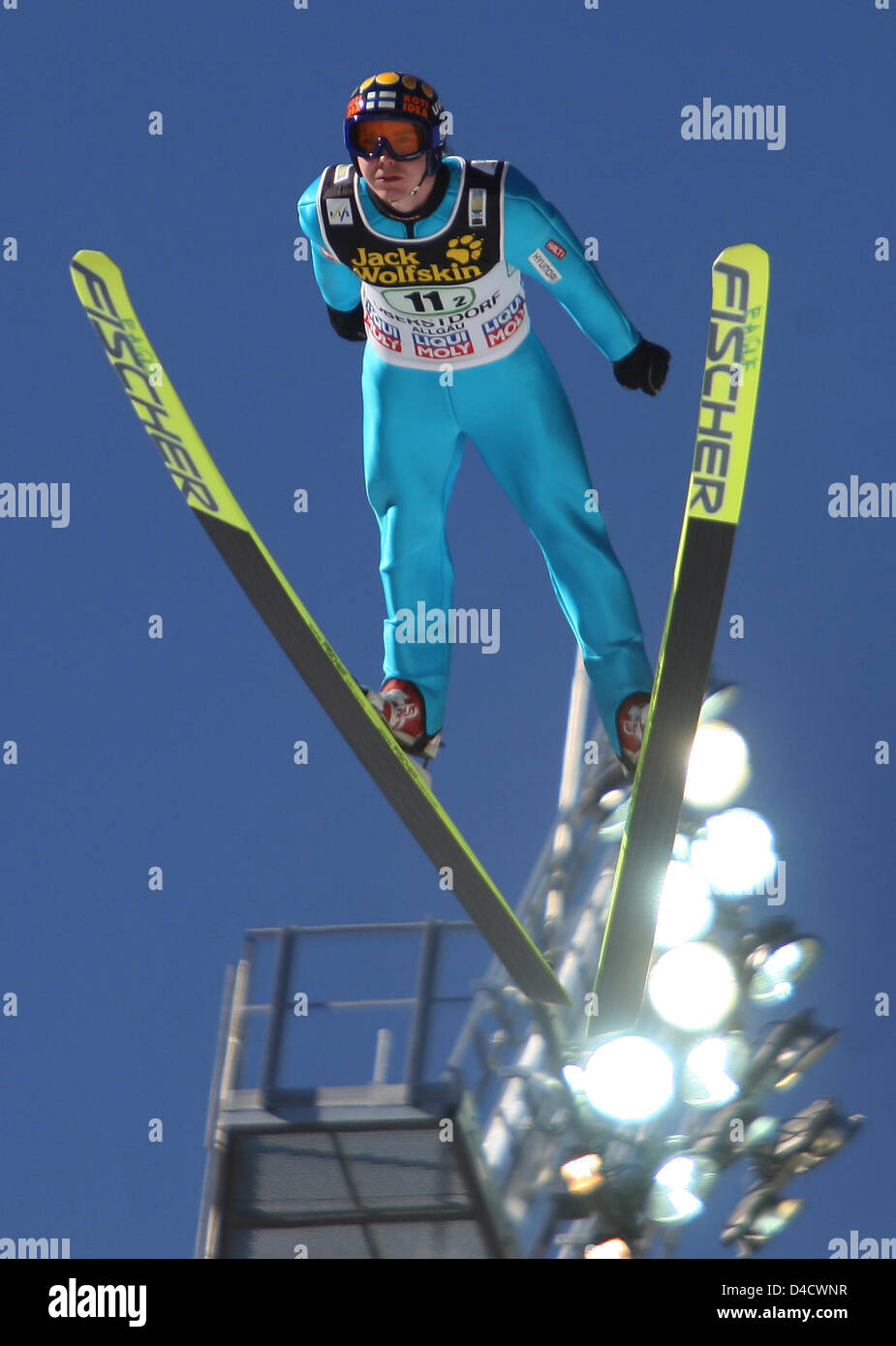 Finnish Harri Olli shown in the air during the team competition of Ski ...