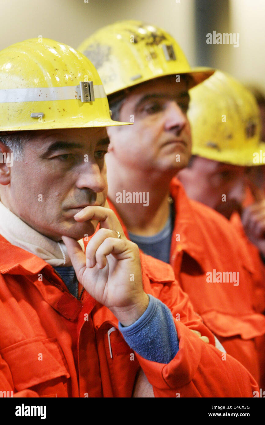 Miners of 'RAG Deutsche Steinkohle' mining company thoughtfully attend ...