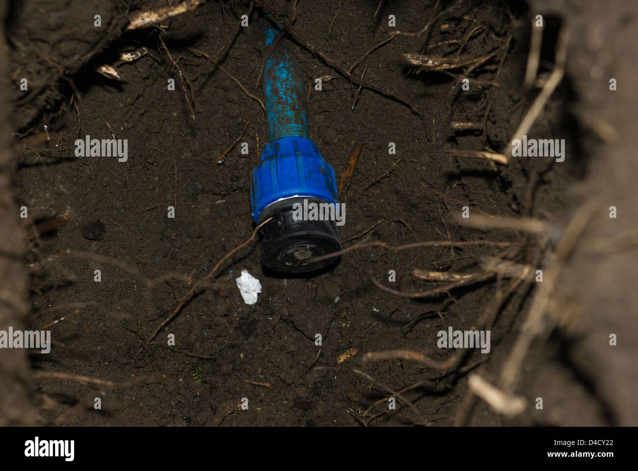 A blue alkathene water pipe capped off in a trench Stock Photo - Alamy
