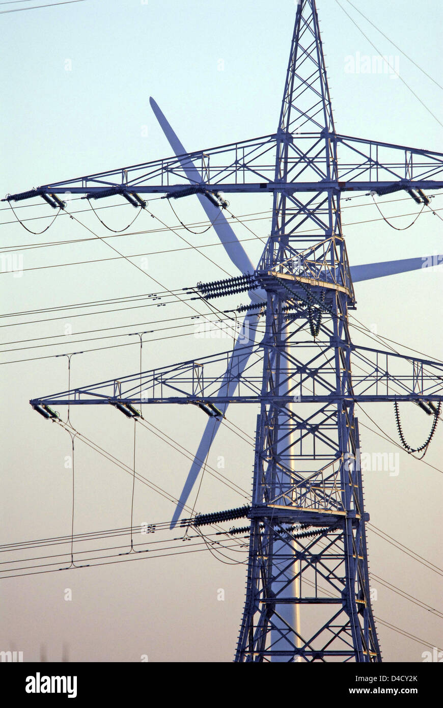 A power pylon and a wind turbine are pictured at dusk near Stade ...