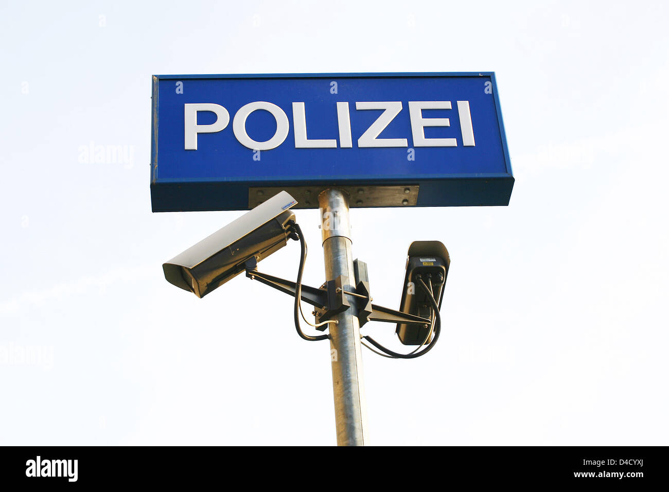 The picture shows two suveillance cameras below a 'Polizei' (Police ...