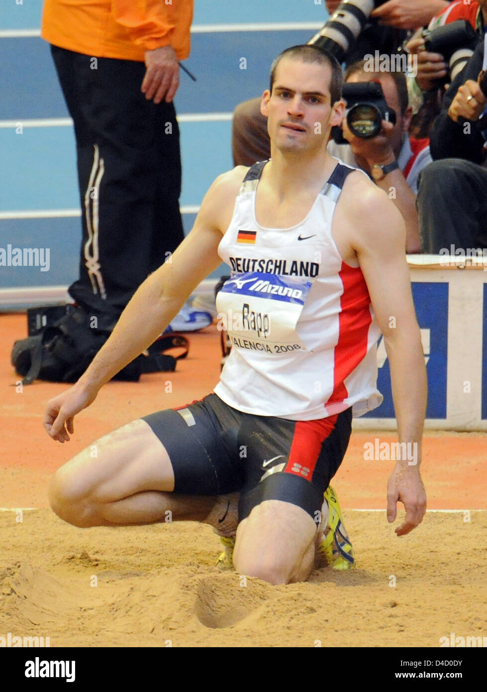 Peter Rapp of Germany kneelsin the sand after an attempt in the Men's ...