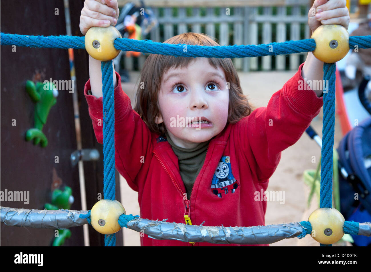 4 year old boy on rope climbing frame Stock Photo - Alamy