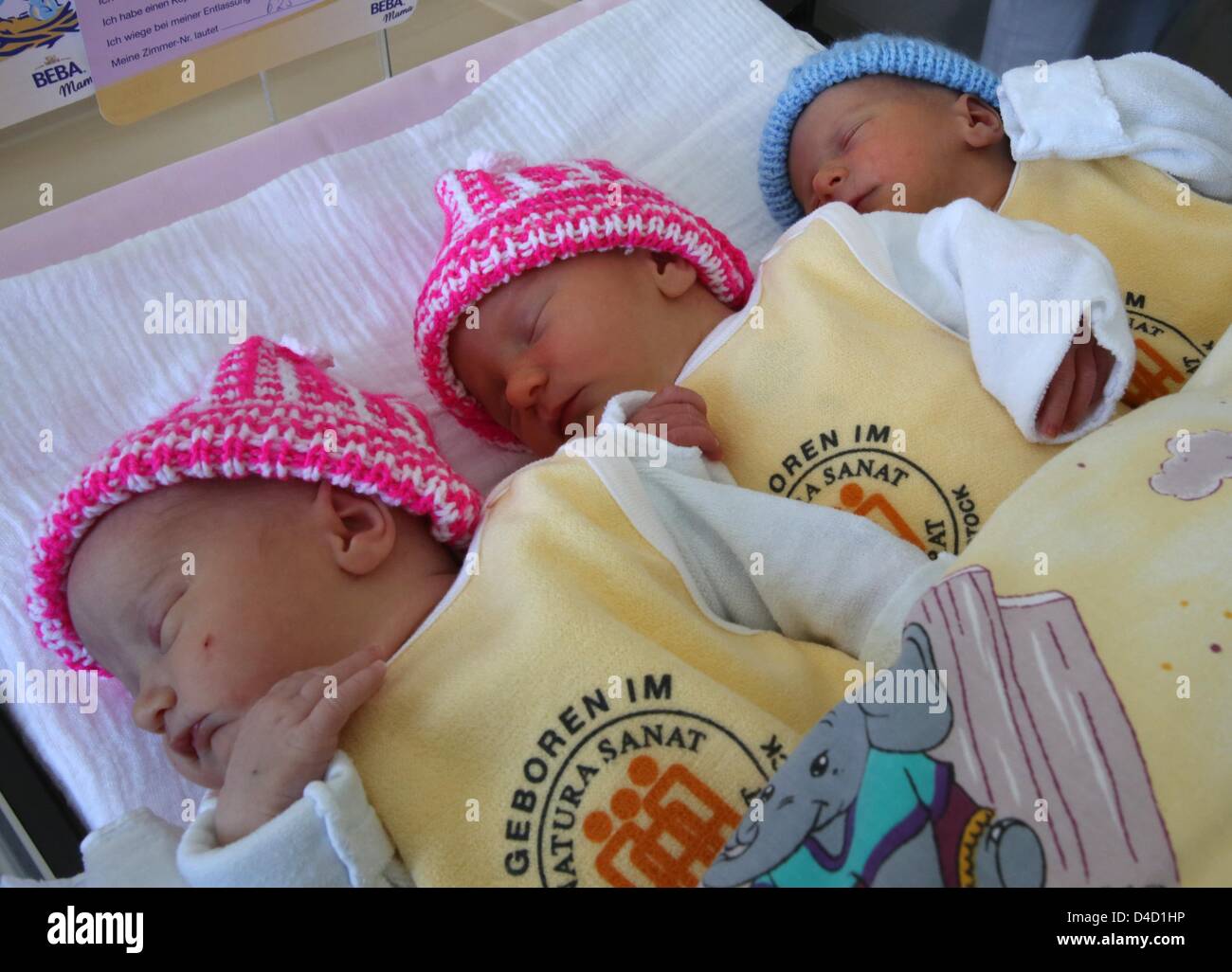 Triplets Emma (L-R), Hermine and Ben sleep in their bed at ...