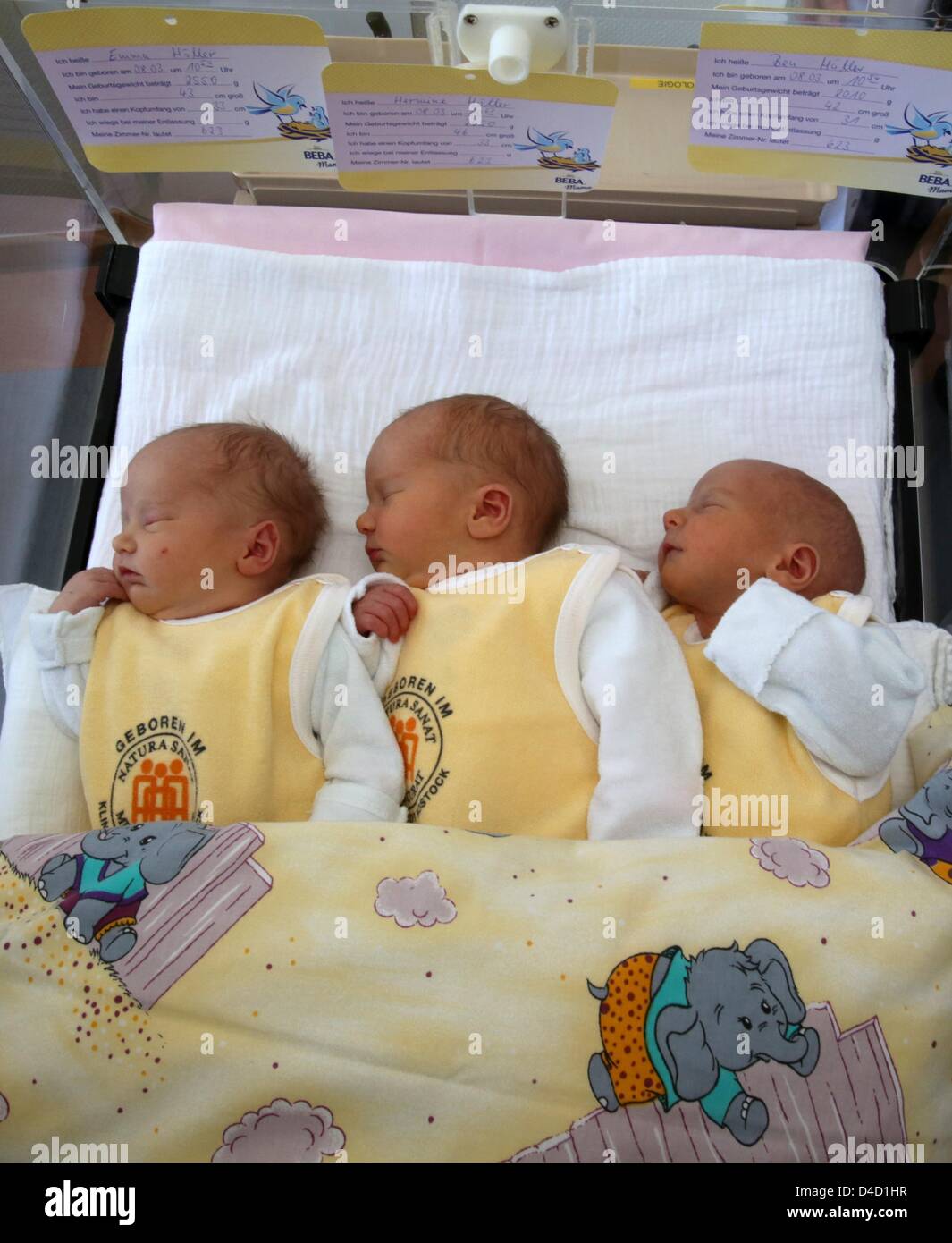 Triplets Emma (L-R), Hermine and Ben sleep in their bed at ...