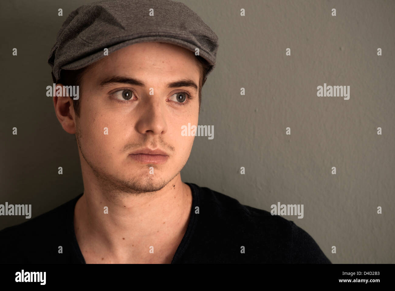 Thoughtful young man wearing cap Stock Photo - Alamy Thoughtful young man wearing cap Stock Photo - Alamy