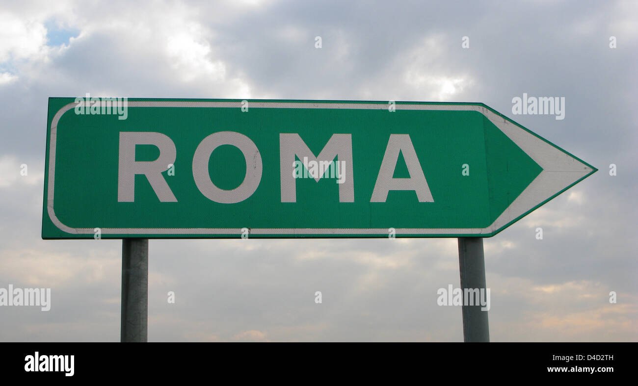 The picture shows a traffic sign indicating the way to 'Roma' on a ...